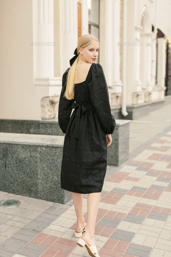 Street style fashion. Girl model in a multiply linen dresses. Pretty ...