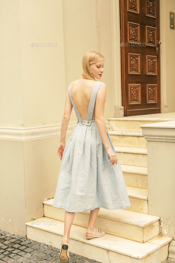 Street style fashion. Girl model in a multiply linen dresses. Pretty ...