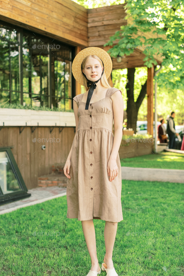 Street style fashion. Girl model in a multiply linen dresses. Pretty ...