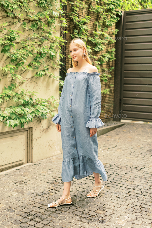 Street style fashion. Girl model in a multiply linen dresses. Pretty ...