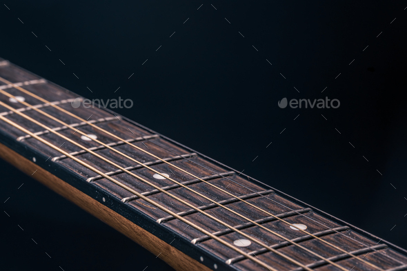 Close-up of an acoustic guitar fretboard copy space. Stock Photo by puhimec