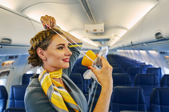 Stewardess using a breathing apparatus during a pre-flight safety ...