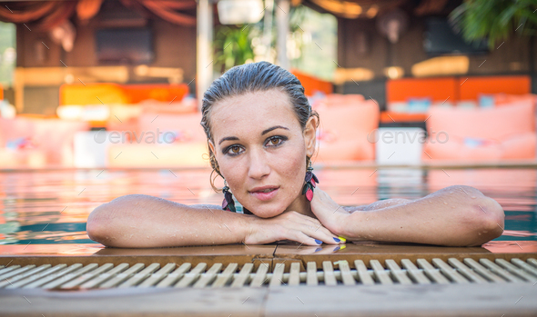 Beautiful woman getting out the swimming pool Stock Photo by ...