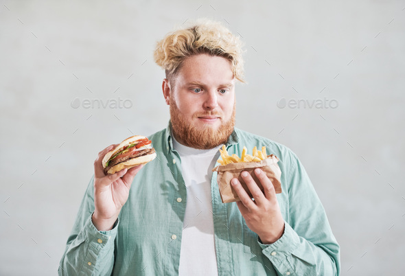 Man eating fast food Stock Photo by AnnaStills | PhotoDune