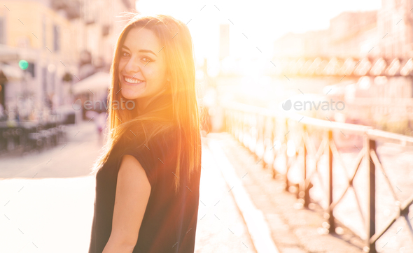 Smiling happy girl looking back at camera Stock Photo by oneinchpunchphotos
