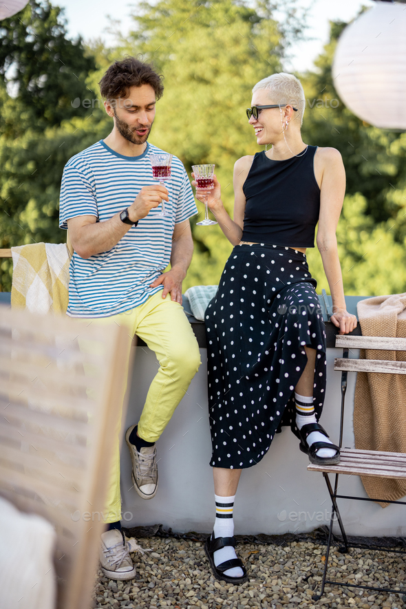 Two friends hanging out at picnic outdoors Stock Photo by RossHelen