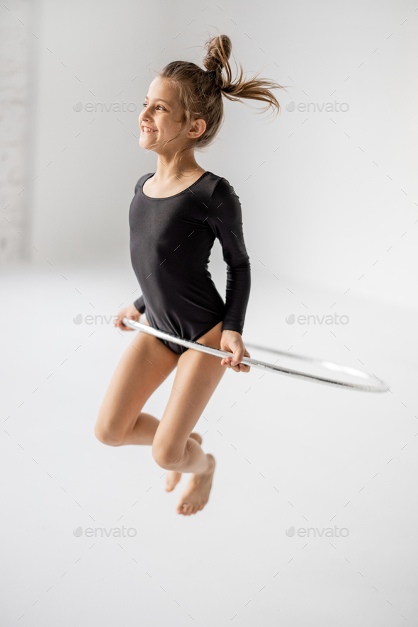 Girl practising rhythmic gymnastic with a ring Stock Photo by RossHelen