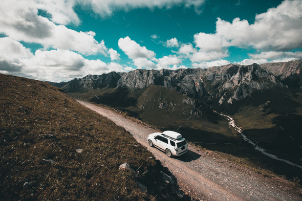 Driving off road car on high altitude mountain top Stock Photo by lzf