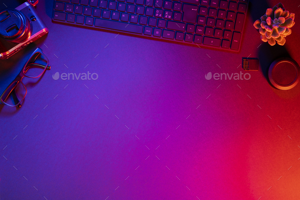 Overhead view of computer keyboard with camera on illuminated table ...