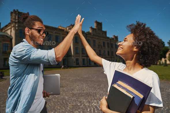Successful students greeting each other after the exam Stock Photo by ...
