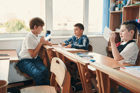 Calm schoolchildren studying in modern comfortable classroom Stock ...