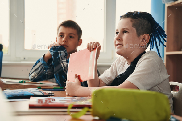 Attentive kids learning new topic and looking interested Stock Photo by ...