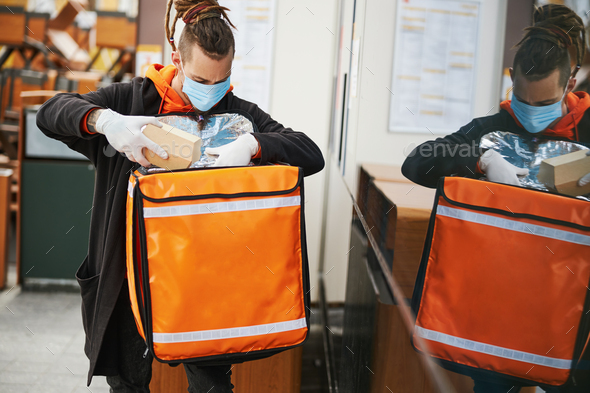 Concentrated male person delivering food for clients Stock Photo by ...