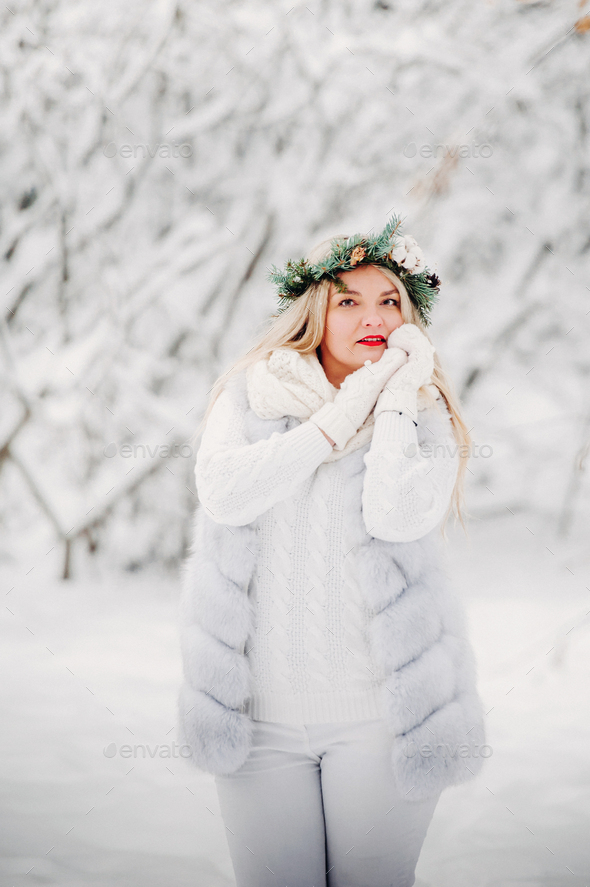 Portrait of a woman in white clothes in a cold winter forest. Girl with ...