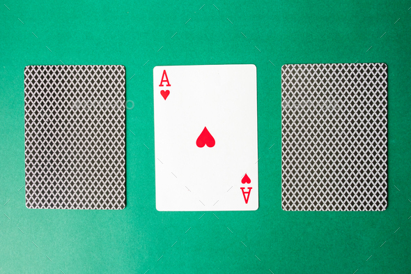 Playing card and back designs on green background. Free space for text ...