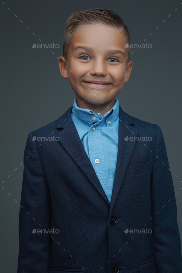 Joyful preschool boy weared in costume against gray background Stock ...