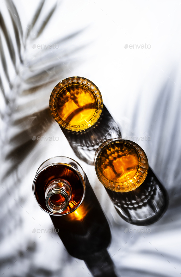 American bourbon whiskey in glasses and bottle, white background with ...