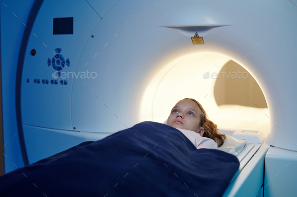 Adorable child moving into mri scan machine before examination Stock ...