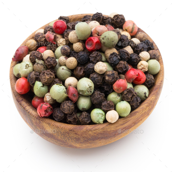 Pepper mix seed on spoon on white background. Stock Photo by GitaKulinica