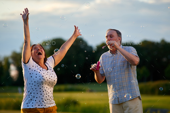 Excited couple blowing bubbles. Stock Photo by stockfilmstudio | PhotoDune