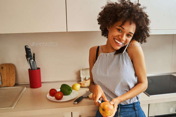 Cook standing by the kitchen countertop during the phone call Stock ...