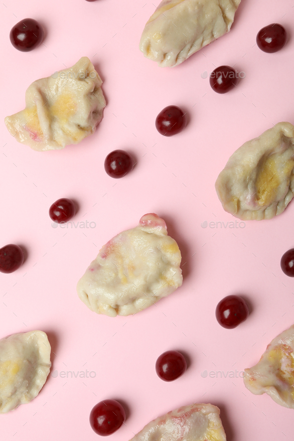 Flat lay with pierogi with cherry on pink background Stock Photo by ...