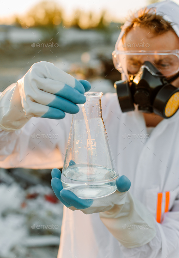 Close-up scientist examining sampling of toxic chemicals on polluted ...