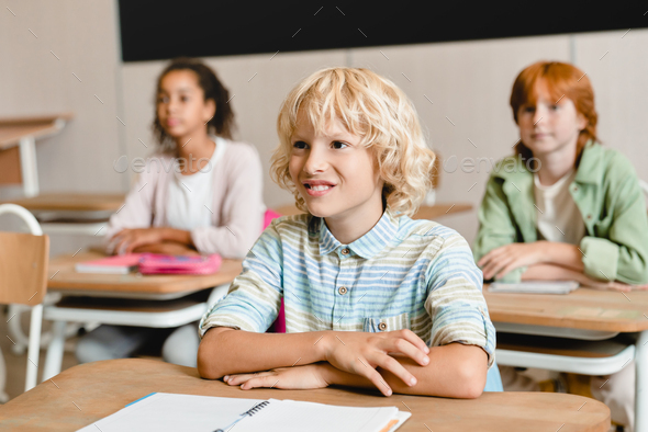 Interested smart pupils classmates group of young students listening ...