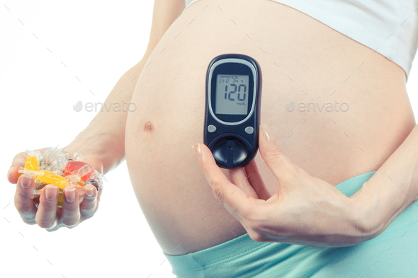 Pregnant woman with glucometer and colorful candies, diabetes and ...