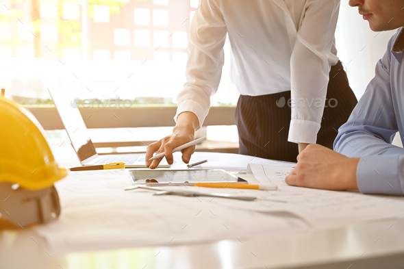 Architect planning blueprint in digital tablet with construction ...