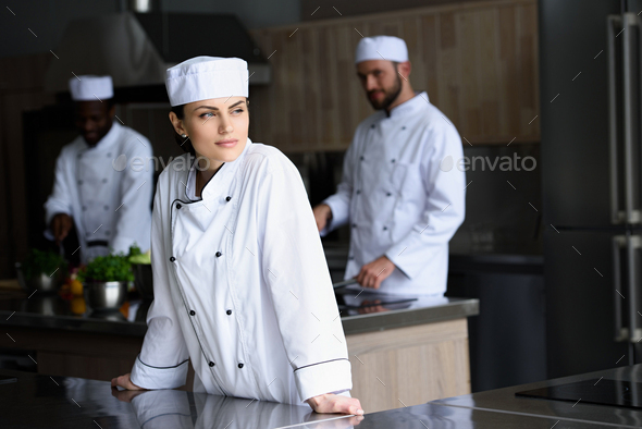 beautiful chef looking away at restaurant kitchen Stock Photo by ...