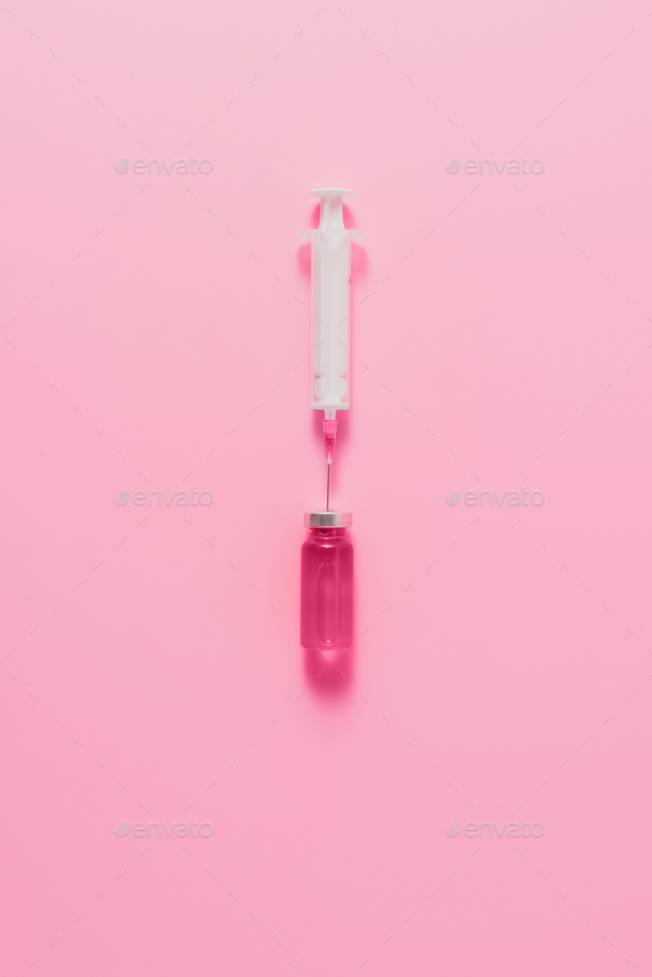 top view of syringe with ampule of pink liquid on pink surface Stock ...
