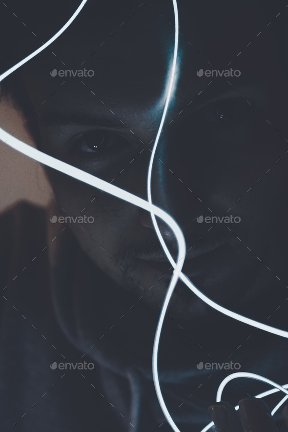 Mysterious and disturbed portrait of a young man in darkness Stock ...