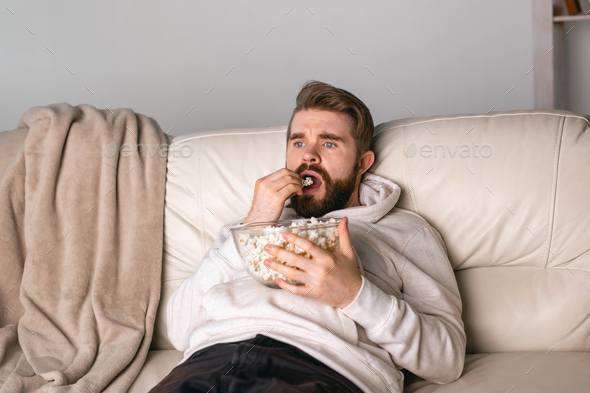 Portrait of guy watching TV series online. Online cinema and video ...