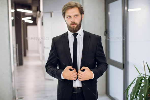 Portrait of a serious Caucasian bearded man office worker, wearing ...