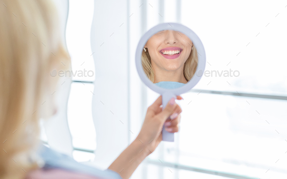 Healthy white smile in hand dental mirror reflection, closeup Stock ...