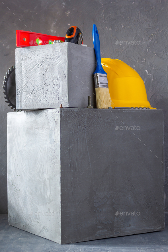 Tools on concrete cube or cement block background texture. Construction ...