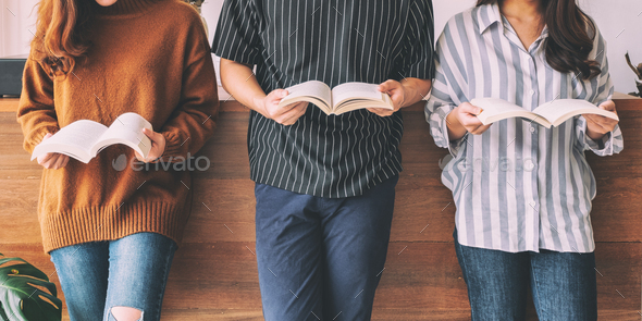 Three young people standing and enjoyed reading books together Stock ...