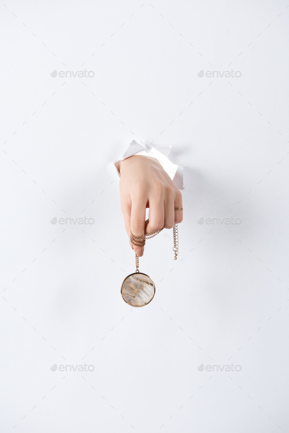 cropped image of woman holding hand with beautiful luxury round locket ...