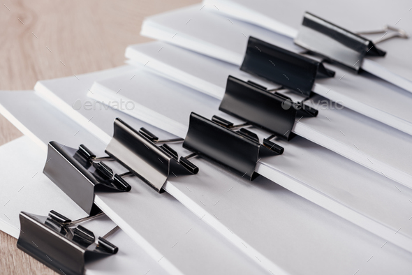 close up view of stacks of blank paper with metal binder clips Stock ...