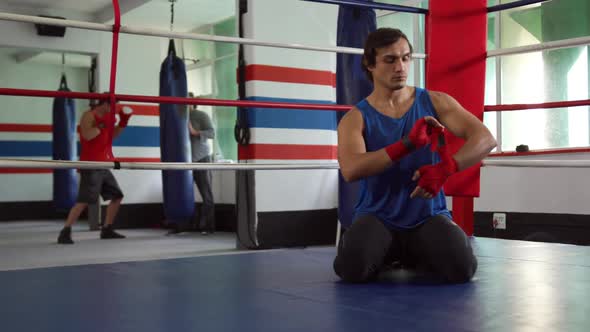 Mixed race man wrapping hands in boxing ring, Stock Footage | VideoHive