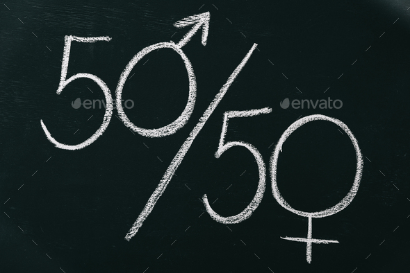 male and female signs as 50 to 50 percents on blackboard, gender ...