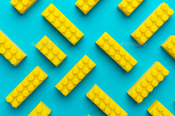 Yellow Plastic Building Blocks Background On Turquoise Blue Stock Photo ...