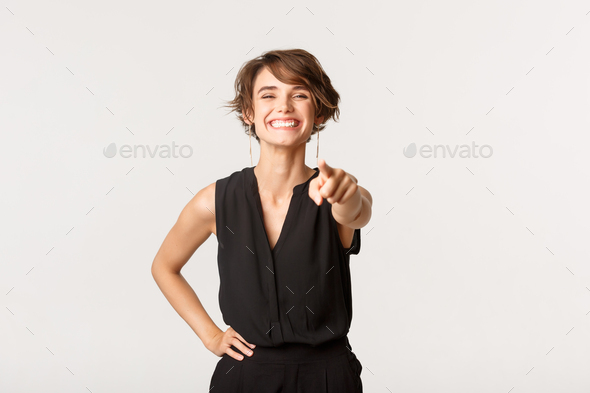 Image of attractive happy woman smiling, pointing finger at you with ...