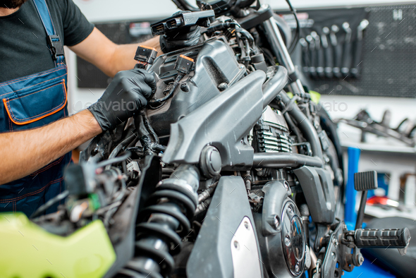 Electrician repairing motorcycle wiring Stock Photo by RossHelen ...