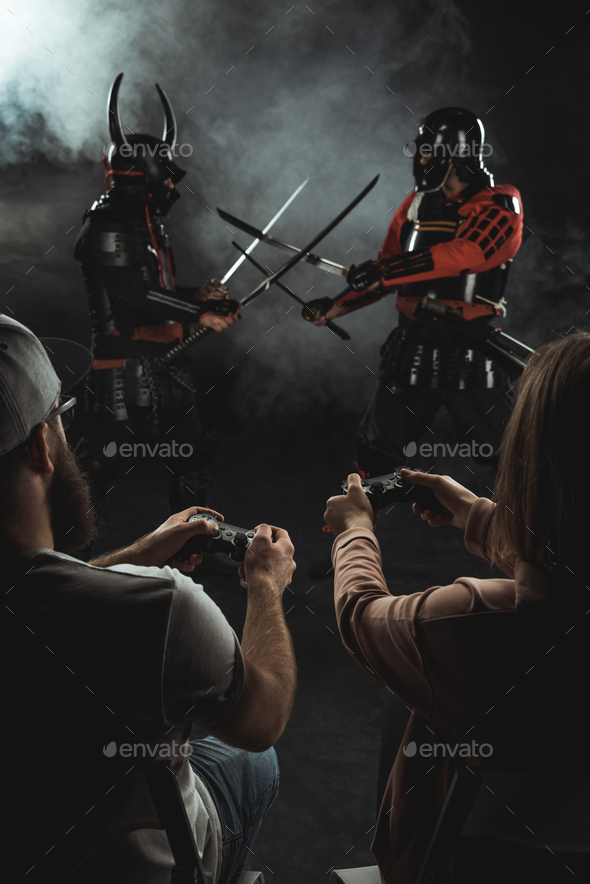 back view of man and woman playing samurai fighting in real life with ...