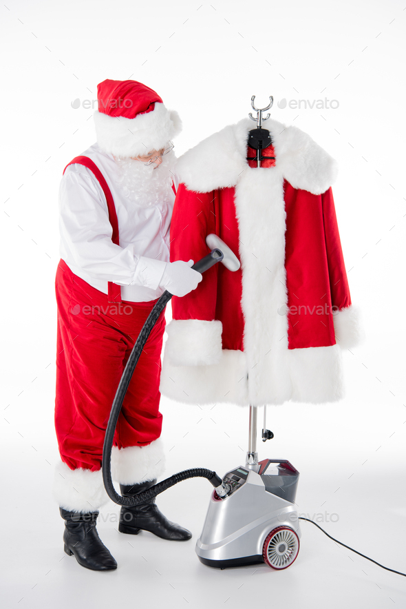 Santa Claus cleaning his coat with vacuum cleaner Stock Photo by ...