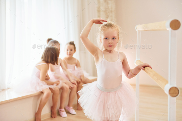 Little ballerinas in pink uniforms preparing for performance Stock ...