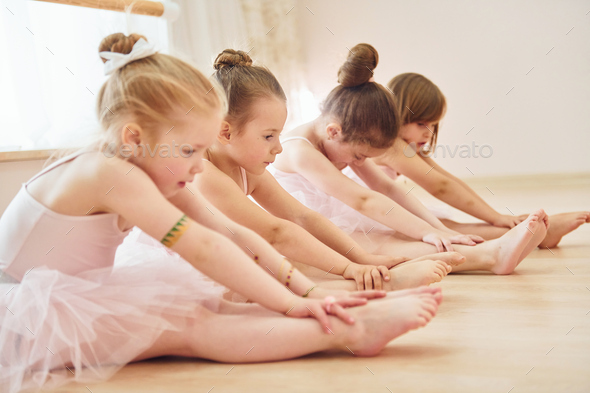 Stretching exercises. Little ballerinas preparing for performance Stock ...