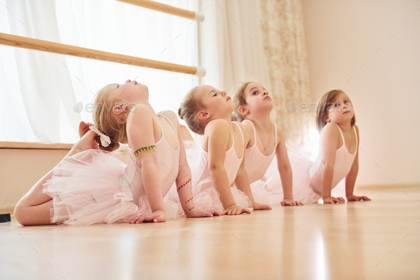 Stretching exercises. Little ballerinas preparing for performance Stock Photo by mstandret